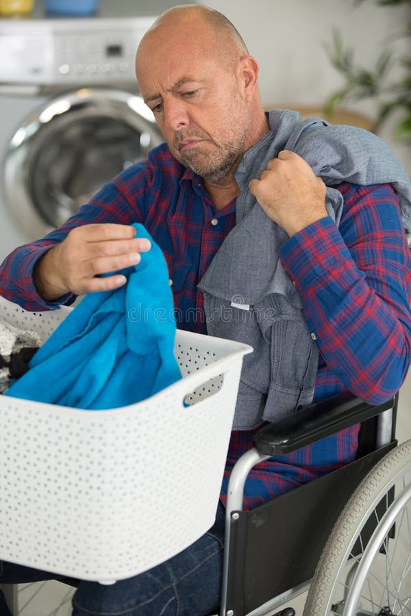 Senior Man in Wheelchair Sorting Laundry Stock Photo - Image of chair ...