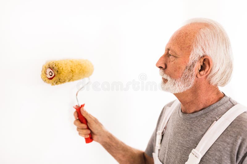 Senior man painting walls stock image. Image of experienced - 270365087