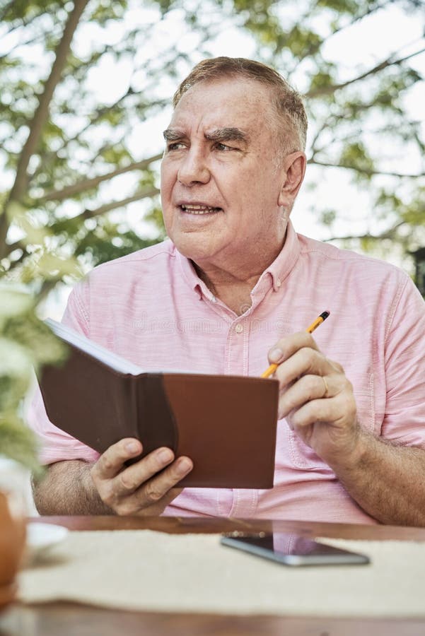 Senior Man Writing in Diary Stock Photo - Image of aged, outdoor: 136798276