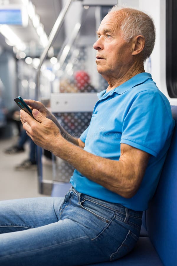 Senior Man Writing Message on Smartphone Screen in Subway Stock Photo ...