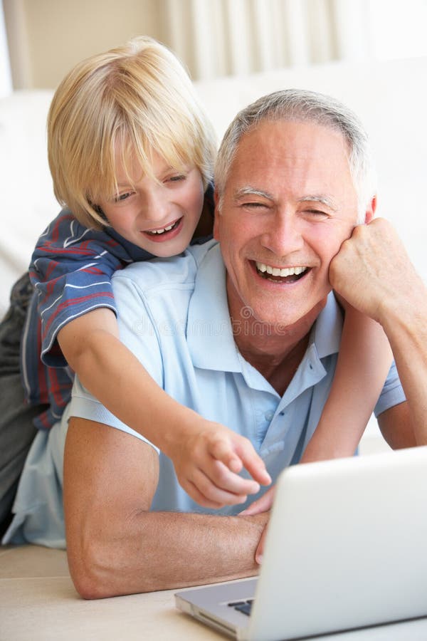 Senior Man with Young Boy Using Laptop Computer Stock Image - Image of ...