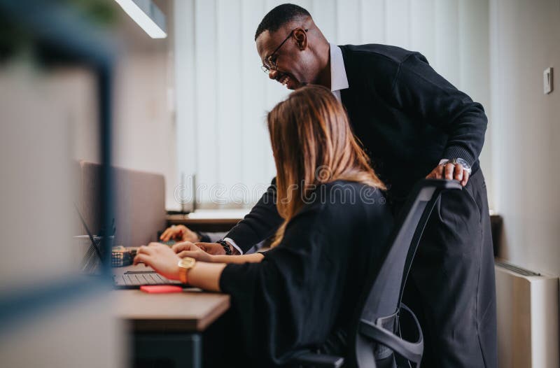Senior Manager Mentoring a Junior Employee at a Modern Office Setup ... Senior Manager Mentoring a Junior Employee at a Modern Office Setup ...