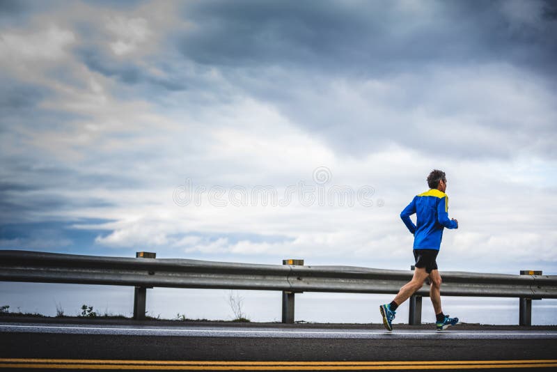 Senior Marathoner Alone on the Side of the Road and Ocean Editorial ...