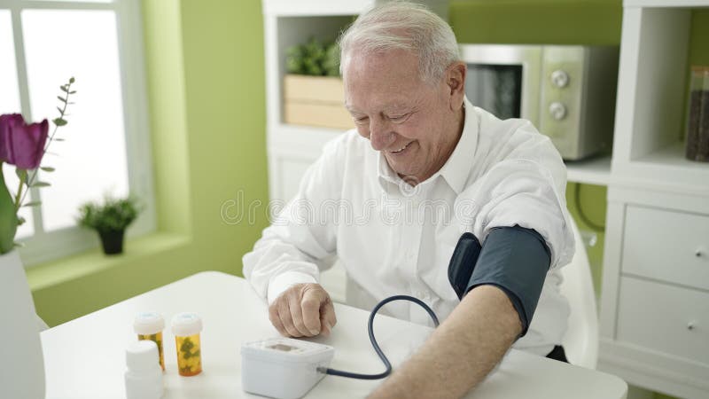 Senior Measuring Pulse Using Tensiometer at Home Stock Photo - Image of ...
