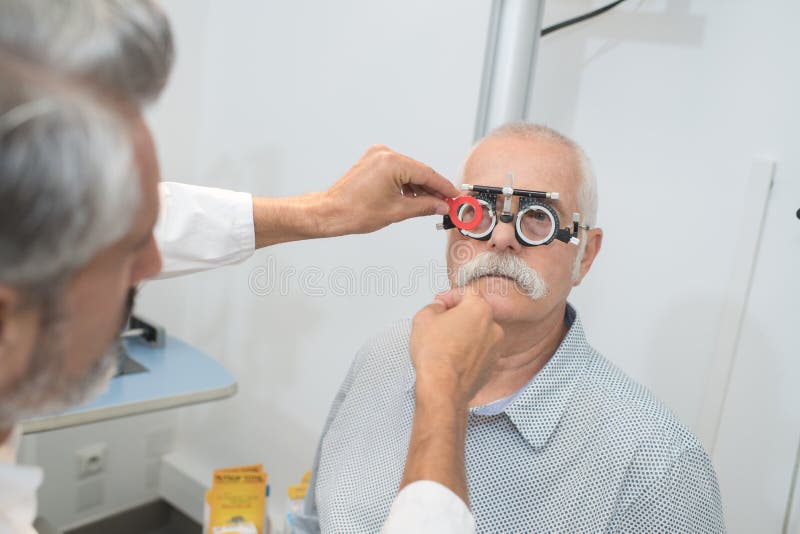 Senior man doing eye test stock photo. Image of aging - 148583550