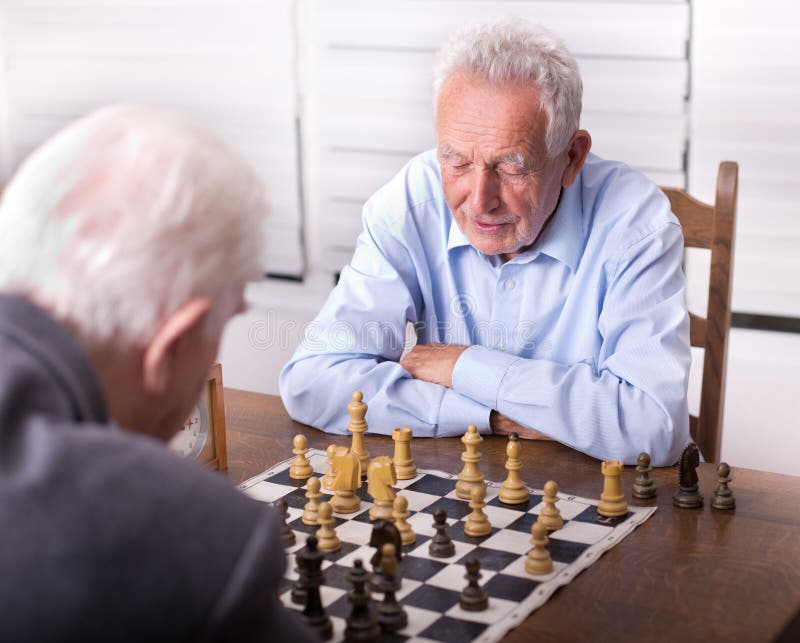 Senior men playing chess stock image. Image of people - 79189091