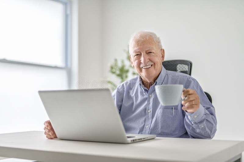 Senior Men Using a Laptop while Sitting at the Office Stock Photo ...