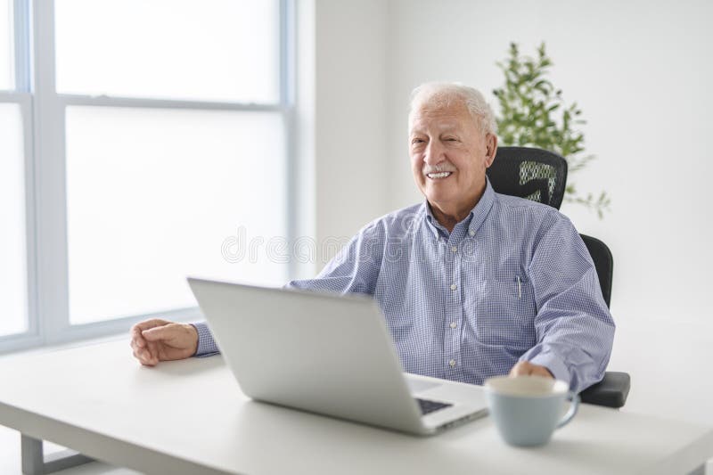 Senior Men Using a Laptop while Sitting at the Office Stock Photo ...
