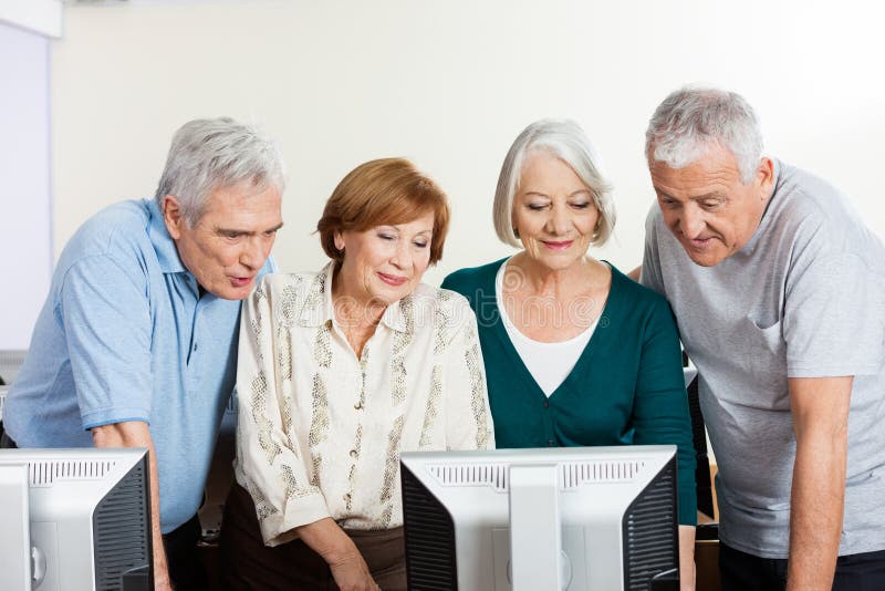 Senior Men and Women Using Computer in Classroom Stock Photo - Image of ...