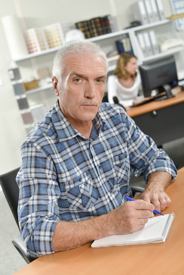 Senior man writing at desk stock image. Image of blank - 102669577