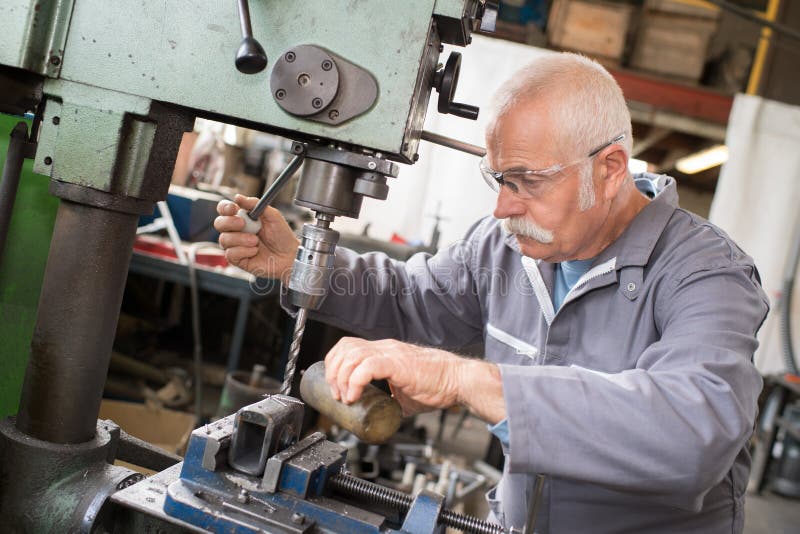 Senior Metal Worker Using Industrial Drilling Machine in Workshop Stock ...