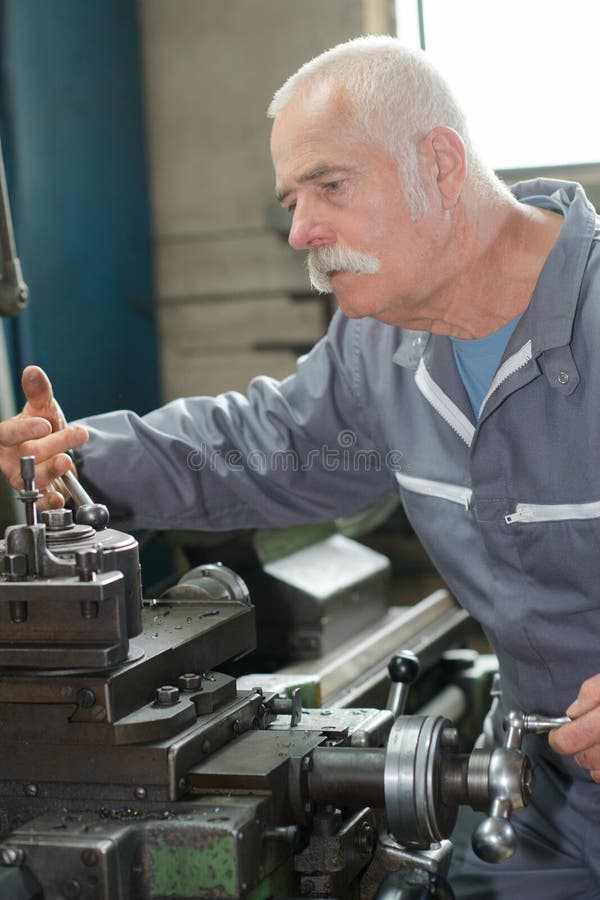Senior Metal Worker Using Machine in Workshop Stock Photo - Image of ...