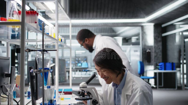 Clinical Microbiologist Uses Microscope for Sample Observation Using PC ...