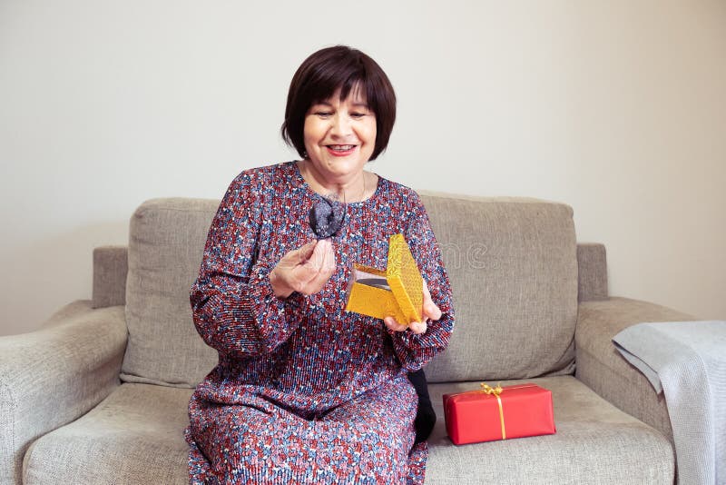 Senior Mom is Opening a Present in a Yellow Box Stock Photo - Image of ...