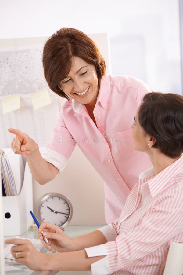 Senior Office Worker Teaching Coworker in Office Stock Image - Image of ...
