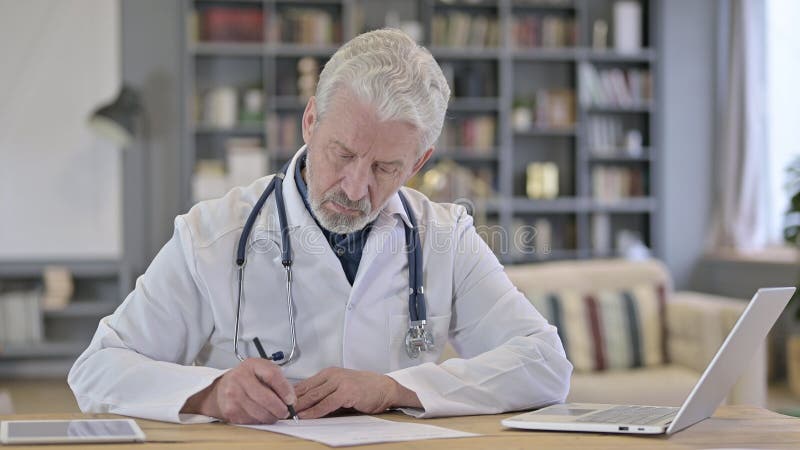 Senior Old Doctor Doing Paperwork in Clinic Stock Image - Image of ...