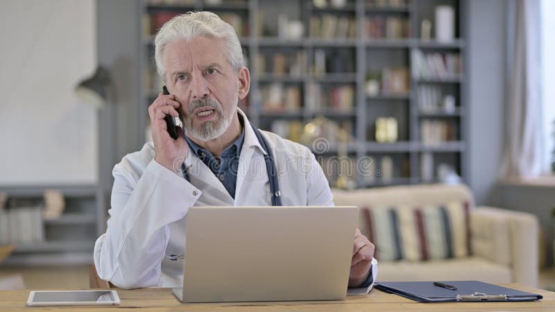 Senior Old Doctor Talking on Smart Phone in Clinic Stock Photo - Image ...