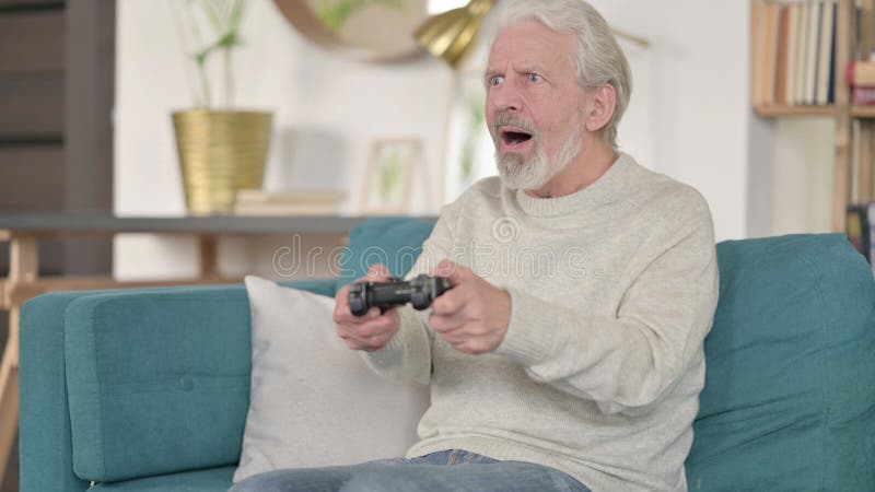 Senior Old Man Celebrating Success on Video Game at Home Stock Photo ...