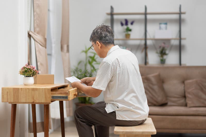 Senior Old Man Reading Documents that Has Forgotten in a Drawer Stock ...