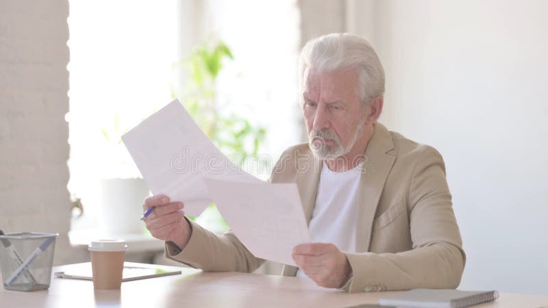 Old Man Reading Documents at Work Stock Image - Image of male, males ...