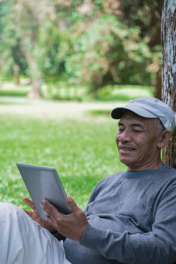 Senior Old Man Using Tablet Pc in the Park Stock Image - Image of sport ...