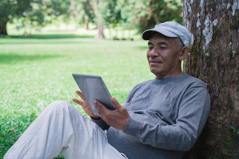 Senior Old Man Using Tablet Pc in the Park Stock Image - Image of ...