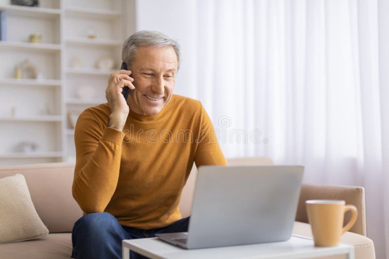 Senior on Phone Call with Laptop in Home Setting Stock Photo - Image of ...