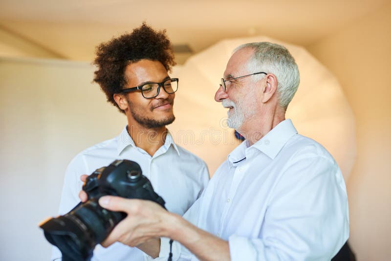 Senior Photographer and Photo Assistant with Camera Stock Image - Image ...