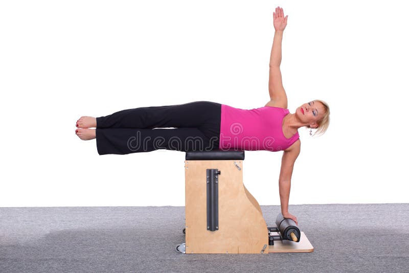 A 50-year-old Trainer Practices Pilates on an Elevator Chair by Lying ...