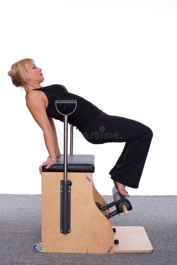 A 20-year-old Trainer Practices Pilates on an Elevator Chair, Raising ...
