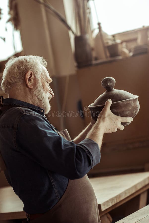 Senior Potter in Apron Examining Ceramic Bowl Stock Photo - Image of ...