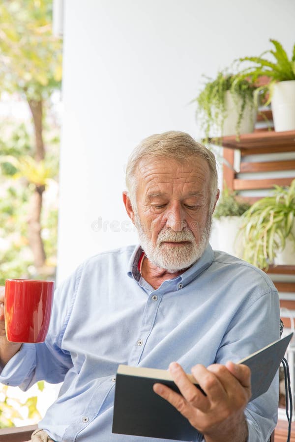 Senior Retirement Man Happy Reading Book at Home Stock Photo - Image of ...