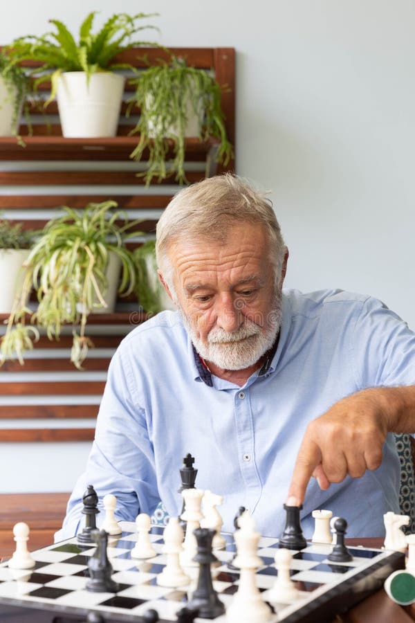 Senior Retirement Man Playing Chess with Himself at Home Stock Image ...