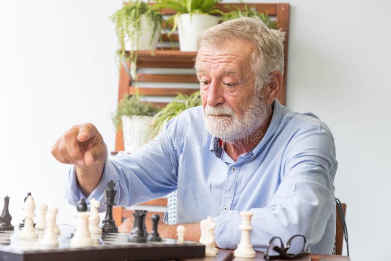 Senior Retirement Man Playing Chess with Himself at Home Stock Image ...