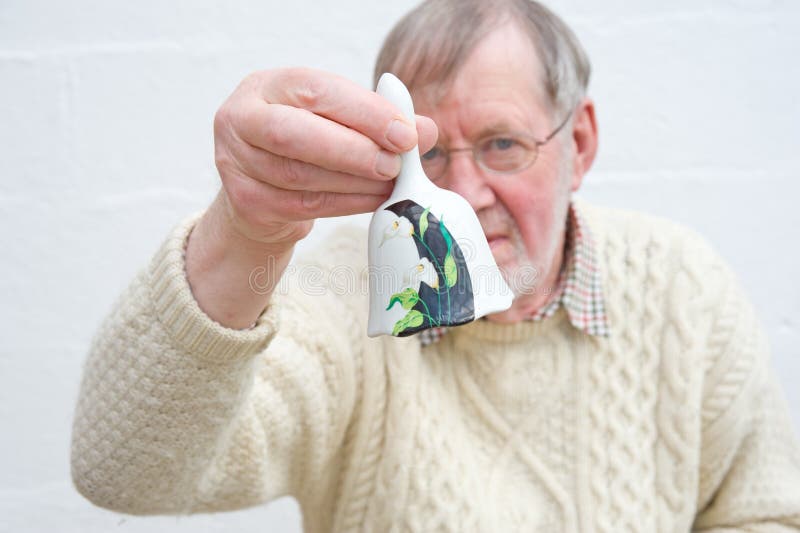 Senior Ringing a Bell To Call for Attention. Stock Photo - Image of ...