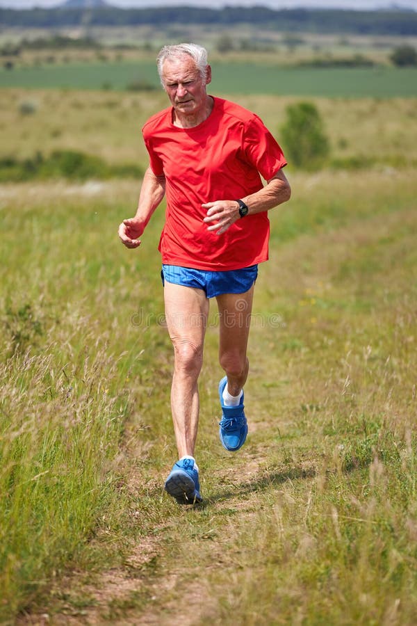 Senior Runner Running on the Meadow Road Stock Image - Image of athlete ...