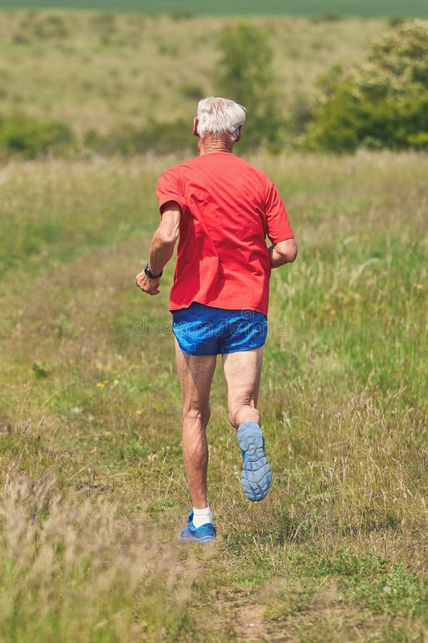 Senior Runner Running on the Meadow at Springtime Stock Photo - Image ...