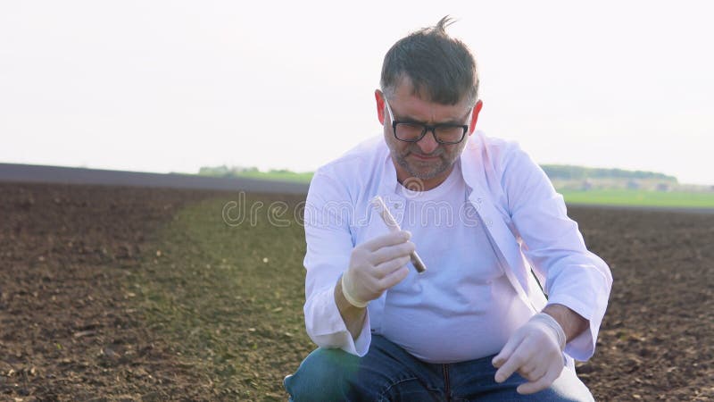 Senior Scientist Studying Sample of Soil in Field. Soil Sampling for ...