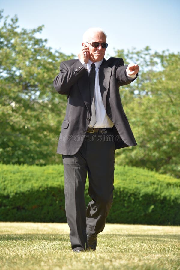 Senior Security Guard Pointing Wearing Sunglasses Walking Stock Photo ...