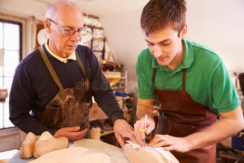 Shoemaker Cutting and Shaping Wood To Make Shoe Lasts Stock Photo ...