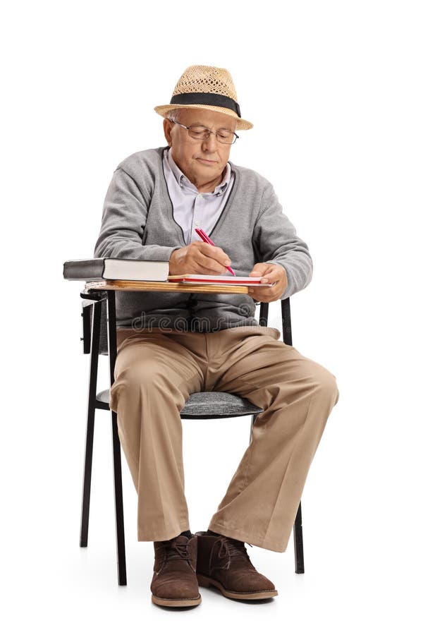 Senior Sitting in a School Chair and Taking Notes Stock Photo - Image ...