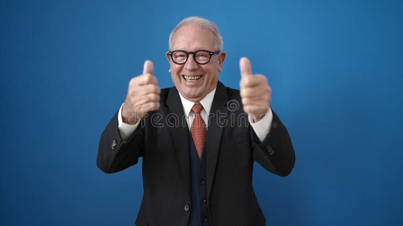 Senior Smiling with Thumbs Up Over Isolated Blue Background Stock Photo ...