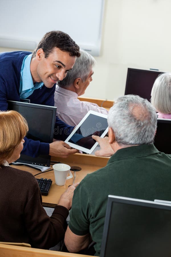 Girl Asking Question To Male Teacher at Desk Stock Image - Image of ...
