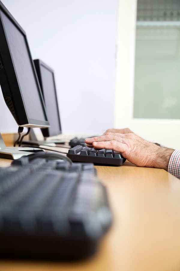 Senior Student Using Computer at Desk Stock Photo - Image of casual ...