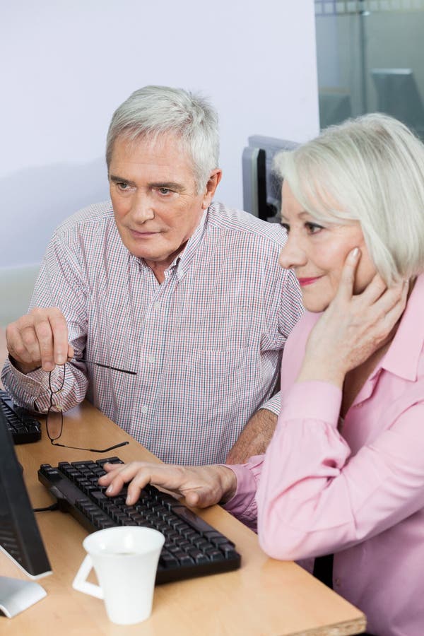 Happy Senior Women at Computer Desk in Classroom Stock Image - Image of ...