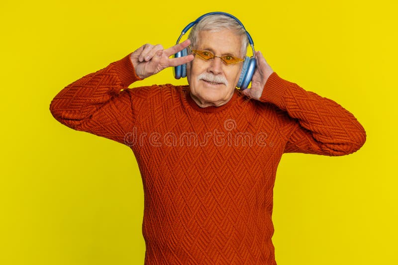Senior Stylish Old Man Listening Music Via Headphones And Dancing