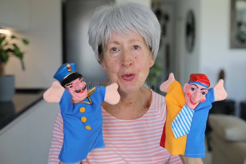 Senior Teacher Holding Some Cute Puppets Stock Image - Image of ...