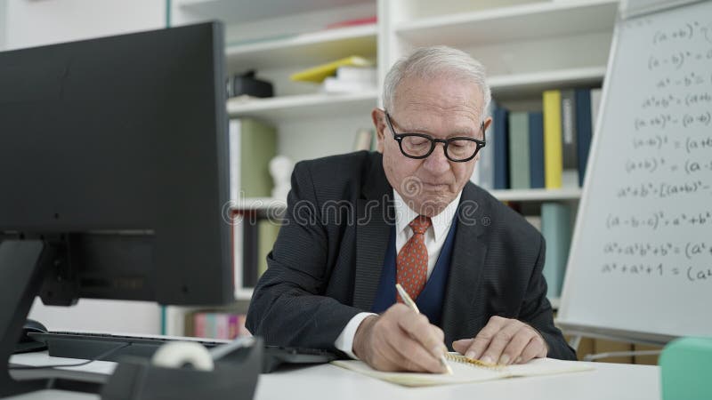 Senior Teacher Using Computer Taking Notes at University Classroom ...