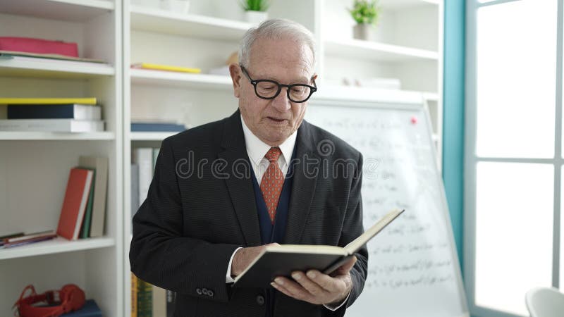 Senior Teaching with Book Standing by White Board at University ...