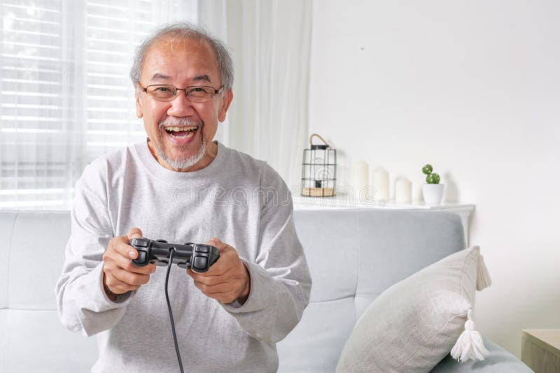 Senior Elderly Laughing on Sofa Using Controller Play Game Stock Image ...